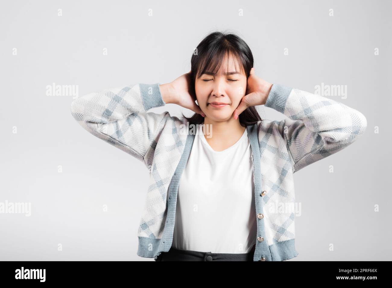 Woman bad mood pain her closed ears with hand palms and close eyes ...