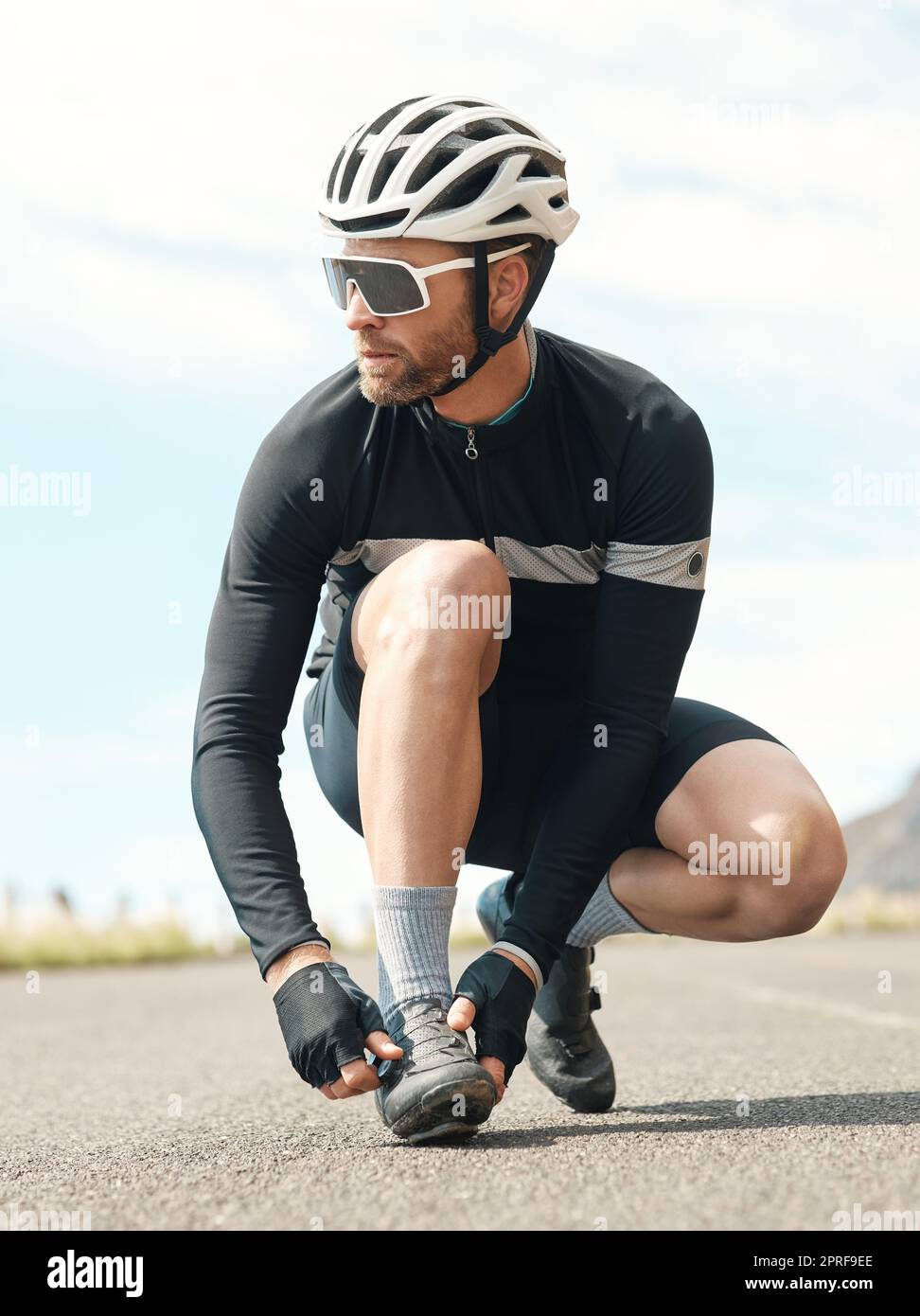 A cycle needs the correct footwear. Full length shot of a handsome ...