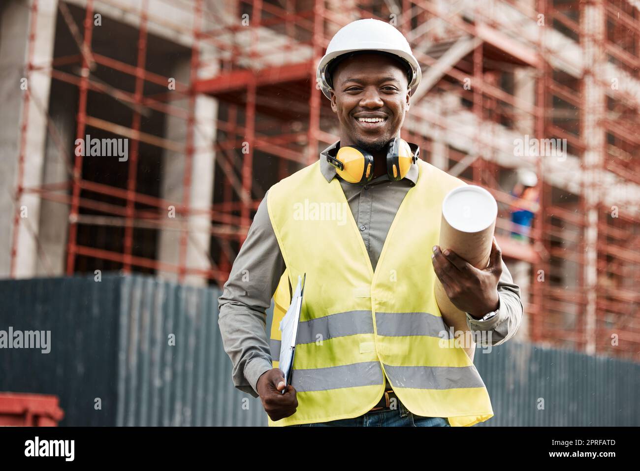 Building the city by hand. a male contractor holding a set of blue ...