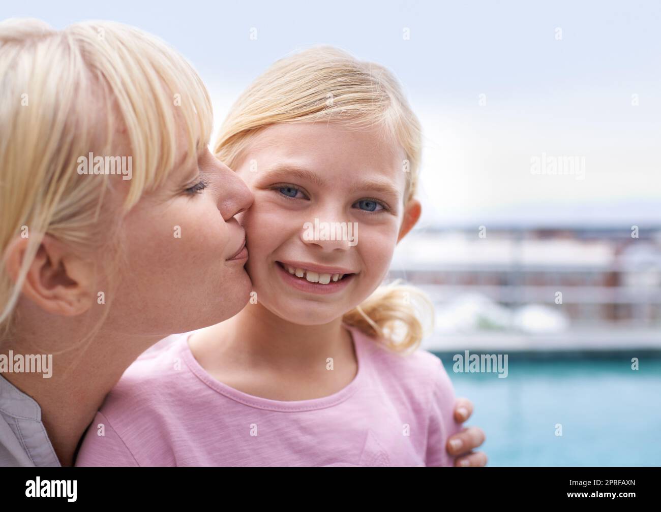Soft As A Mothers Kiss A Loving Mother Giving Her Daughter A Kiss On