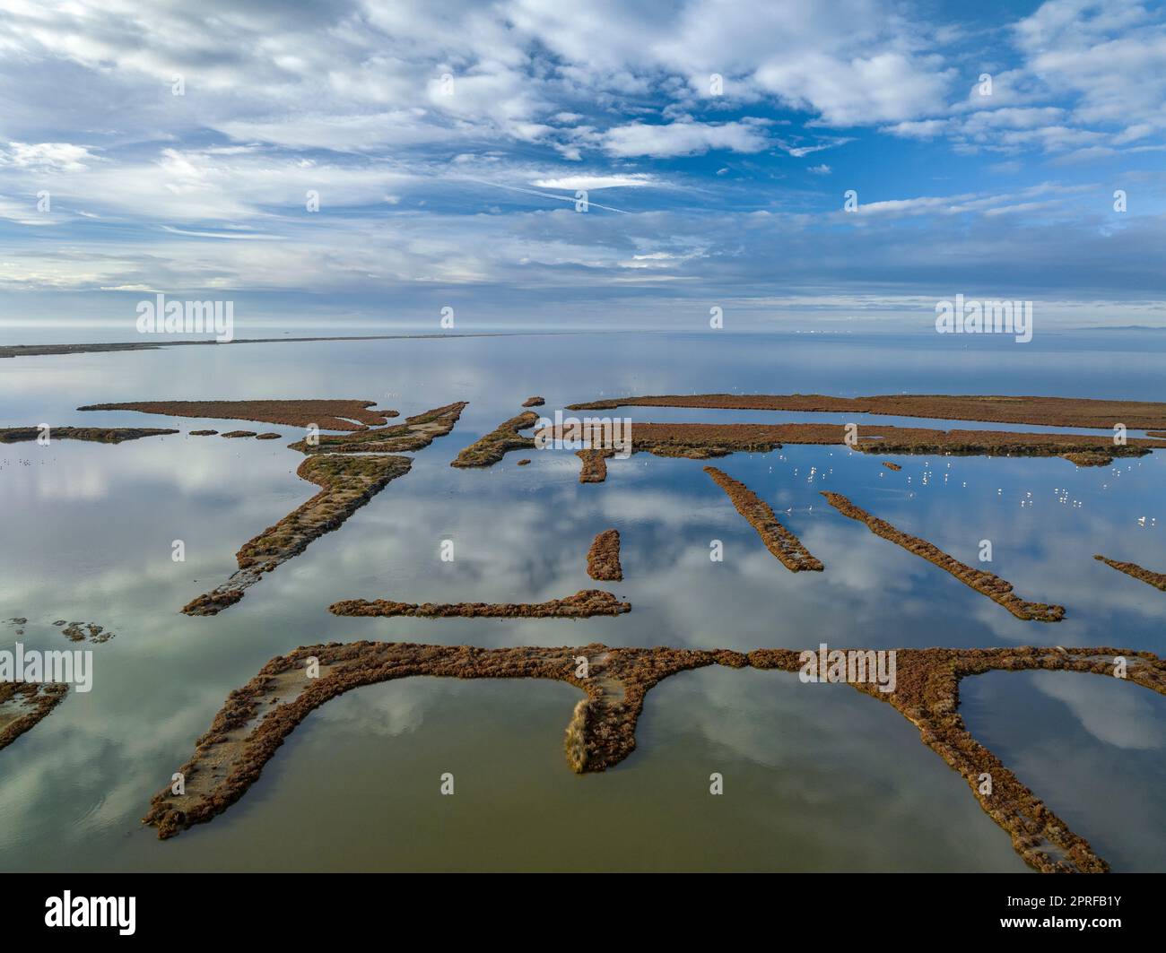 Aerial view of the wetlands of the old saltworks of Sant Antoni next to ...