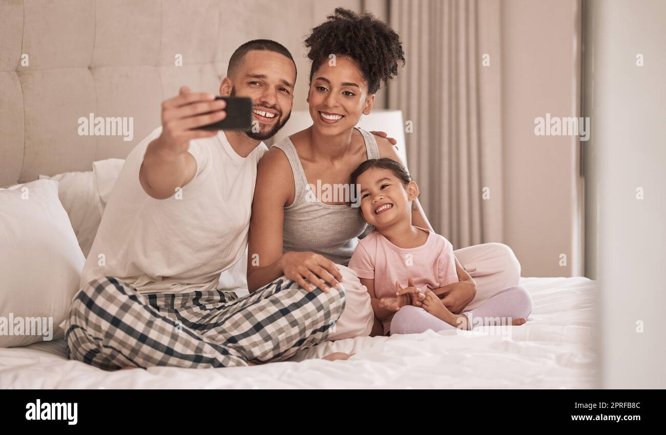 Selfie, phone and child with a mother, father and their girl kid ...