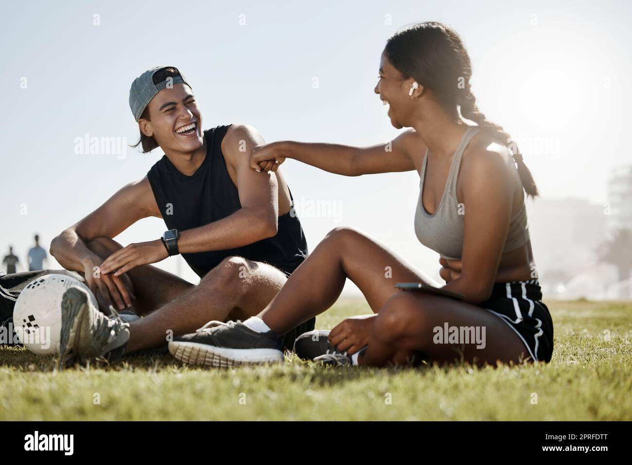 Fitness, friends and soccer grass break by man and woman relax, laugh ...