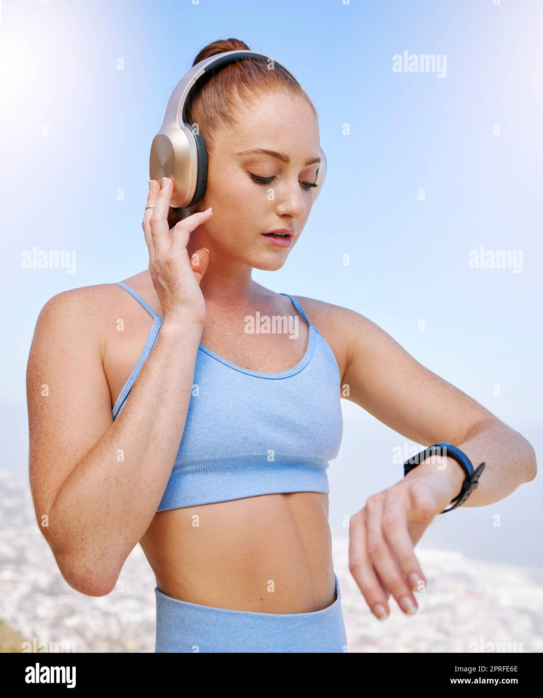 Fitness, runner and woman on time by her smartwatch as she monitors her ...