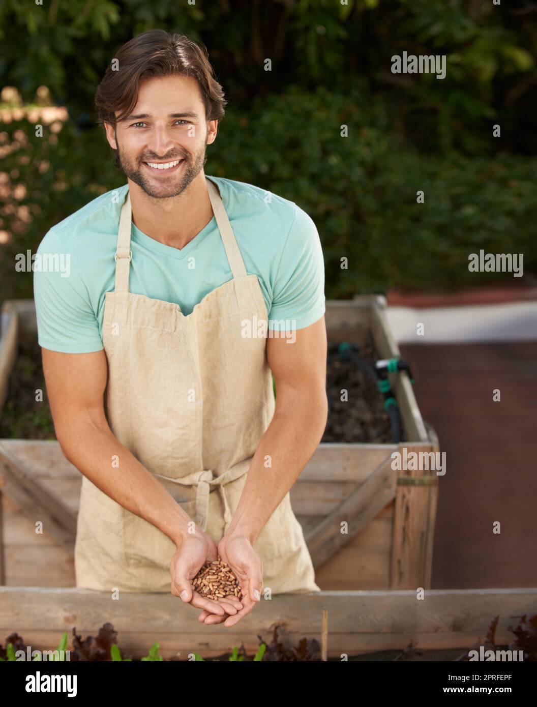 Spring means planting...Portrait of a handsome young garden holding ...