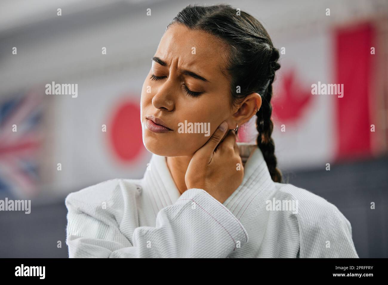 Woman karate student with bad neck pain at fitness training studio ...
