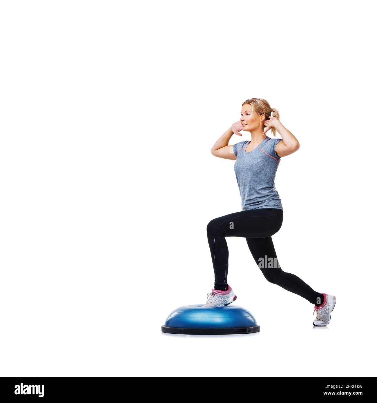 She follows a strict workout plan. An attractive young woman toning her ...