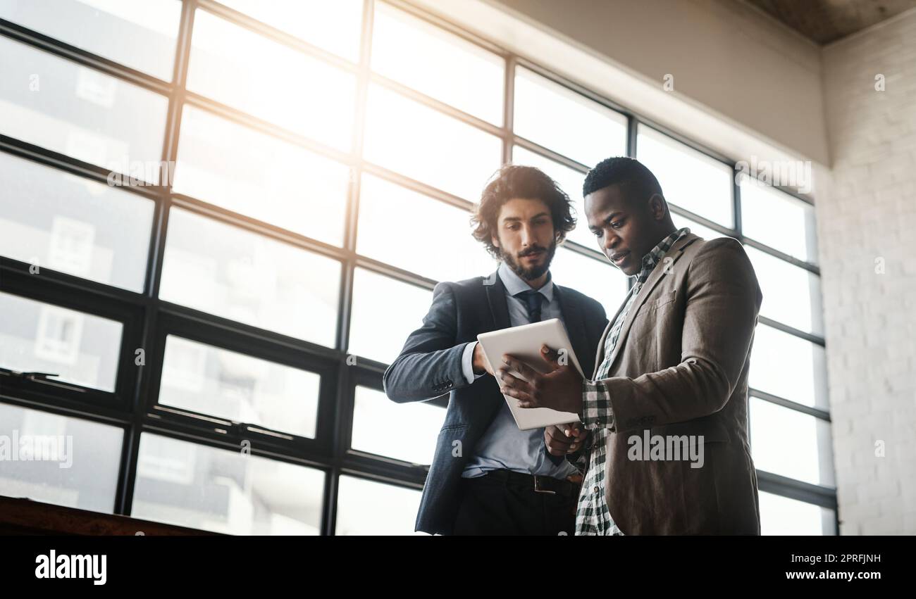 This is interesting...Low angle shot of two well-dressed businessmen ...