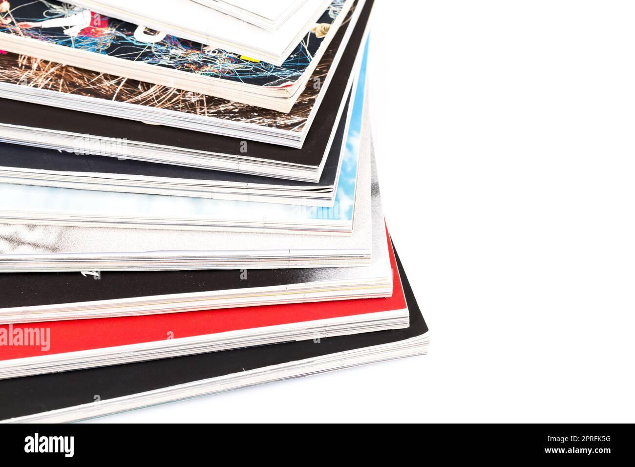 Magazines stack up close shot on white background Stock Photo - Alamy
