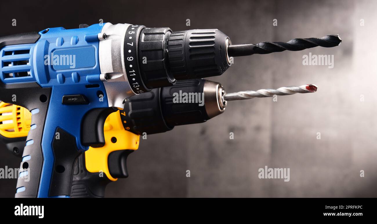 Two cordless drills with drill bits working also as screw guns Stock ...