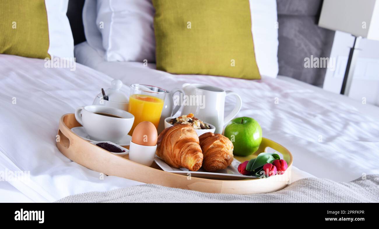 Breakfast on tray in bed in hotel room Stock Photo - Alamy