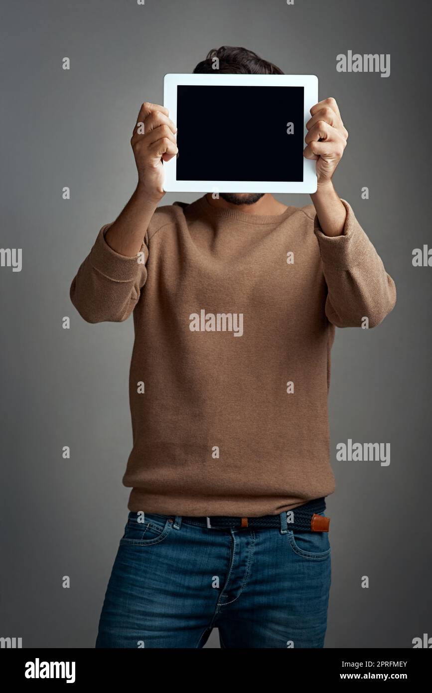 Man with tablet covering face hi-res stock photography and images - Alamy