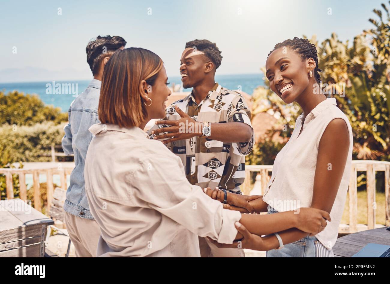 Friends, hugging and looking happy while meeting outside a restaurant ...