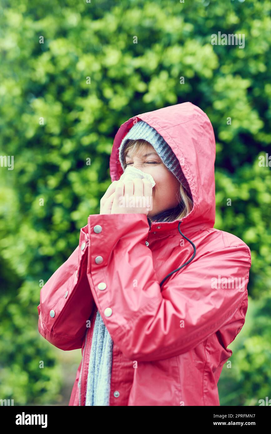 It feels great to blow my nose. a young woman blowing her nose with a ...