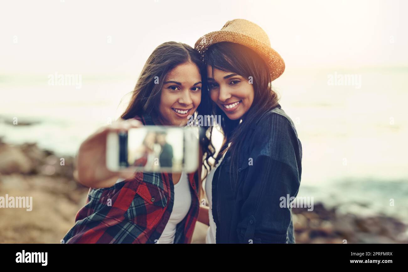 Beaching it with my bestie. two young friends taking a selfie together ...