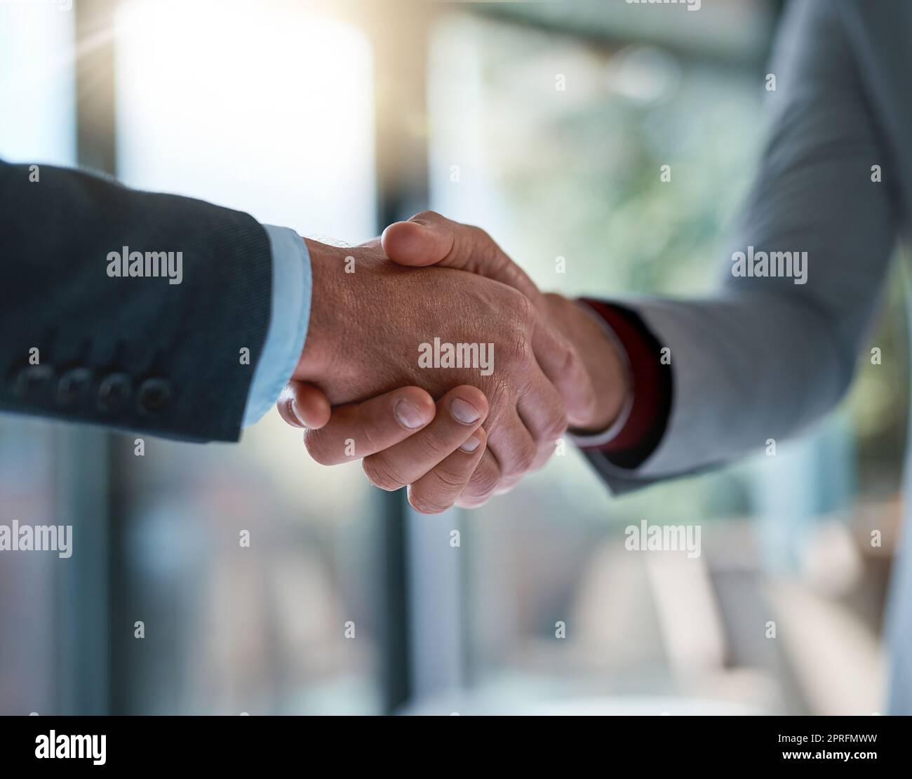 Merging for success. two unrecognizable businessmen shaking hands after ... Merging for success. two unrecognizable businessmen shaking hands after ...