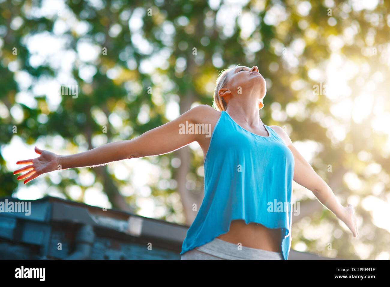 Im free at last. Low angle shot of a mature woman feeling free and ...