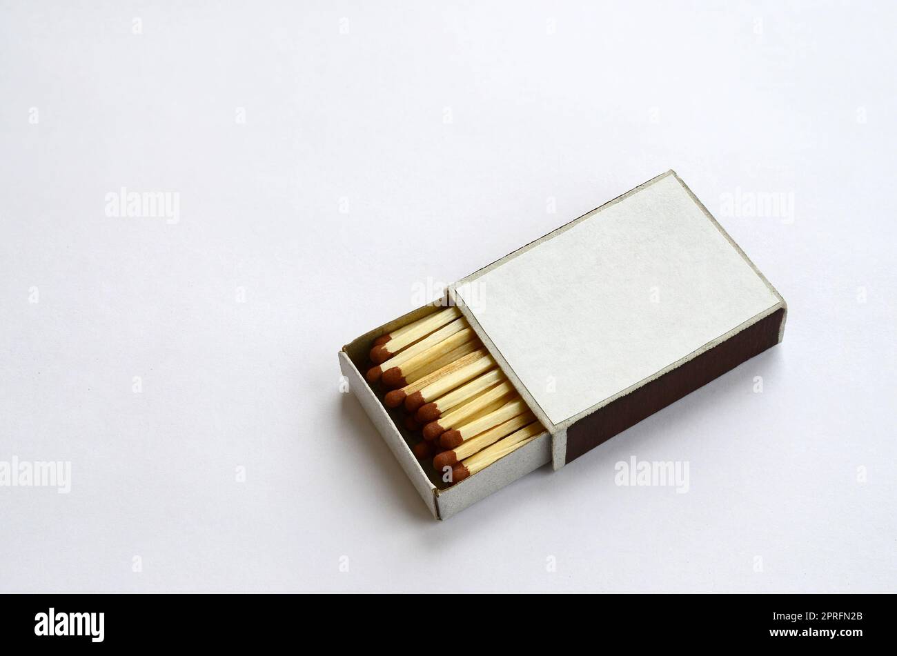 Open cardboard matchbox filled with matches on a white background. Flat ...