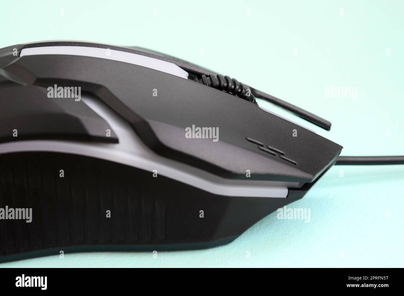 Closeup of a black gaming optical mouse on a blue background. Device ...