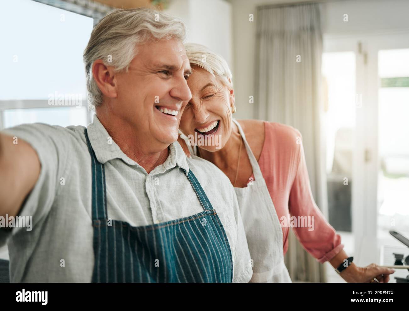 Elderly Couple And Selfie In Home Happy While Cooking Baking Or