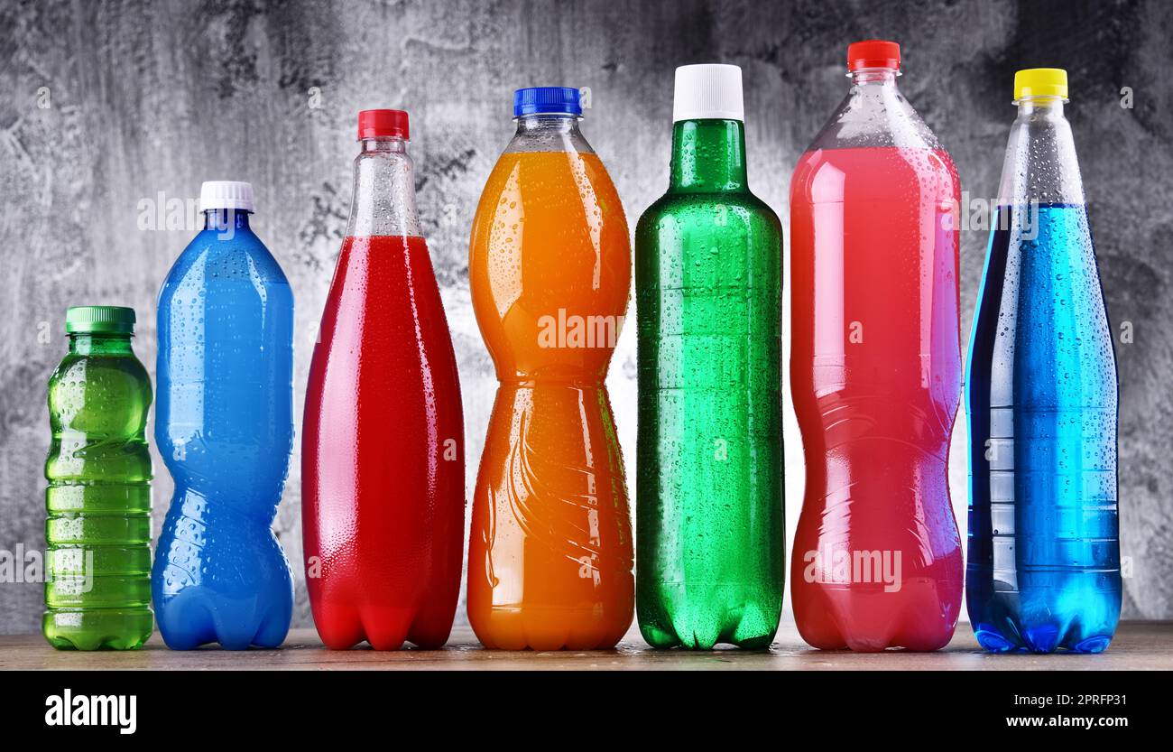 Plastic bottles of assorted carbonated soft drinks in variety of colors ...