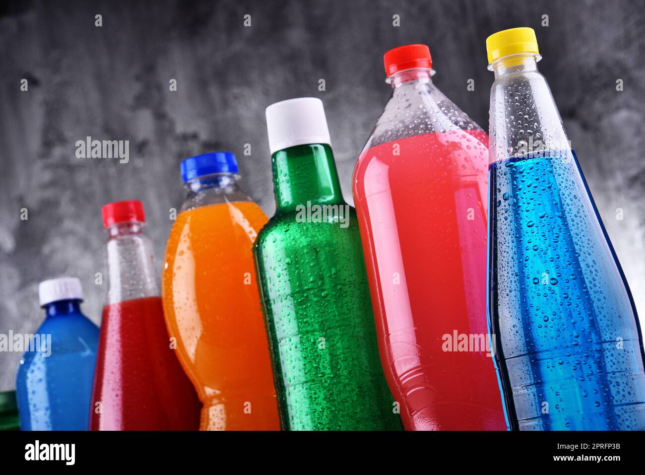 Plastic bottles of assorted carbonated soft drinks in variety of colors ...