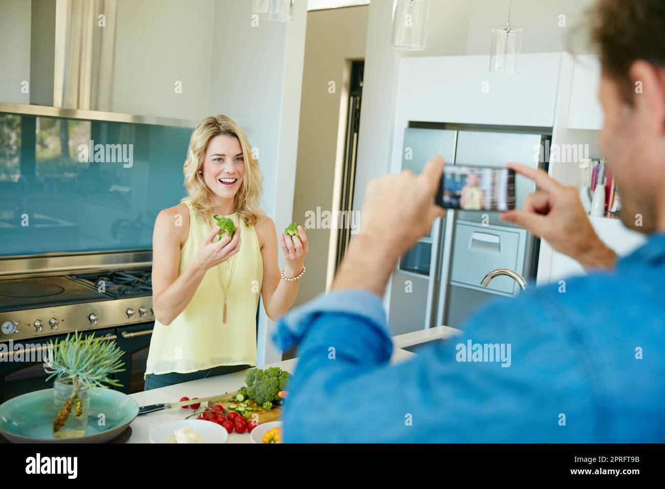 Showing off her cooking skills on cam. a husband taking snapshots of ...