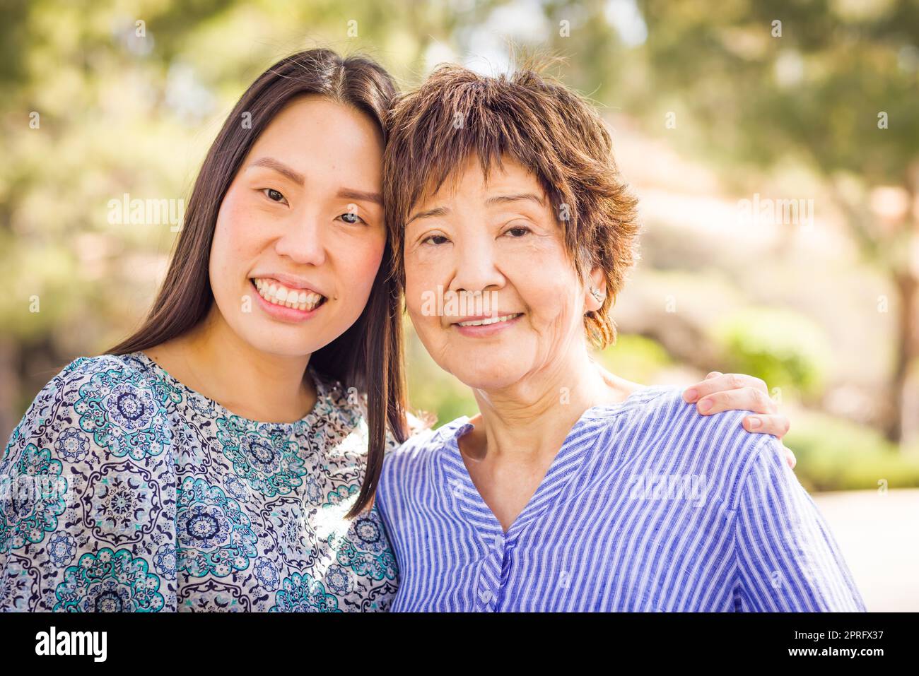 Outdoor portrait of a happy Chinese mother and daughter Stock Photo - Alamy