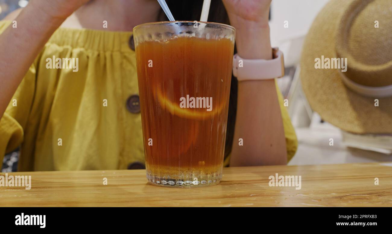 Woman holding glass iced tea hi-res stock photography and images - Alamy