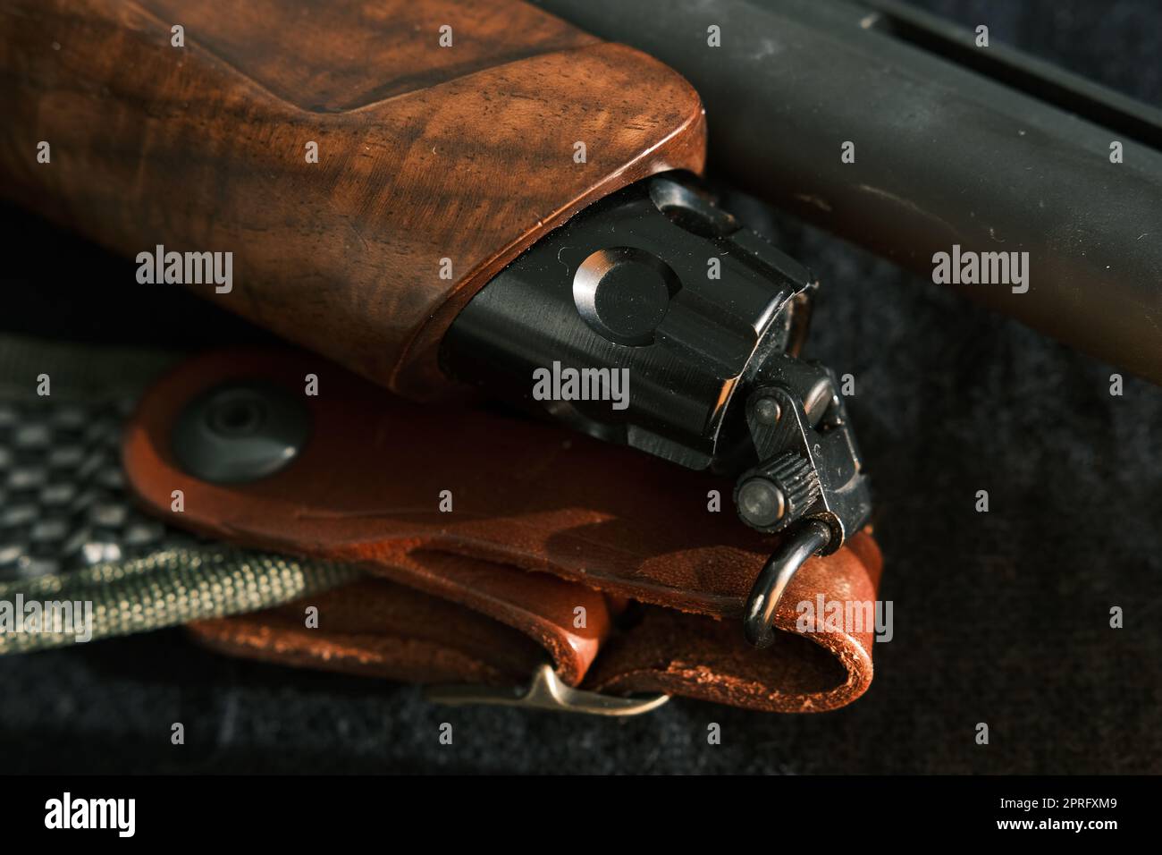 shell magazine into the barrel of a long shotgun on dark background ...