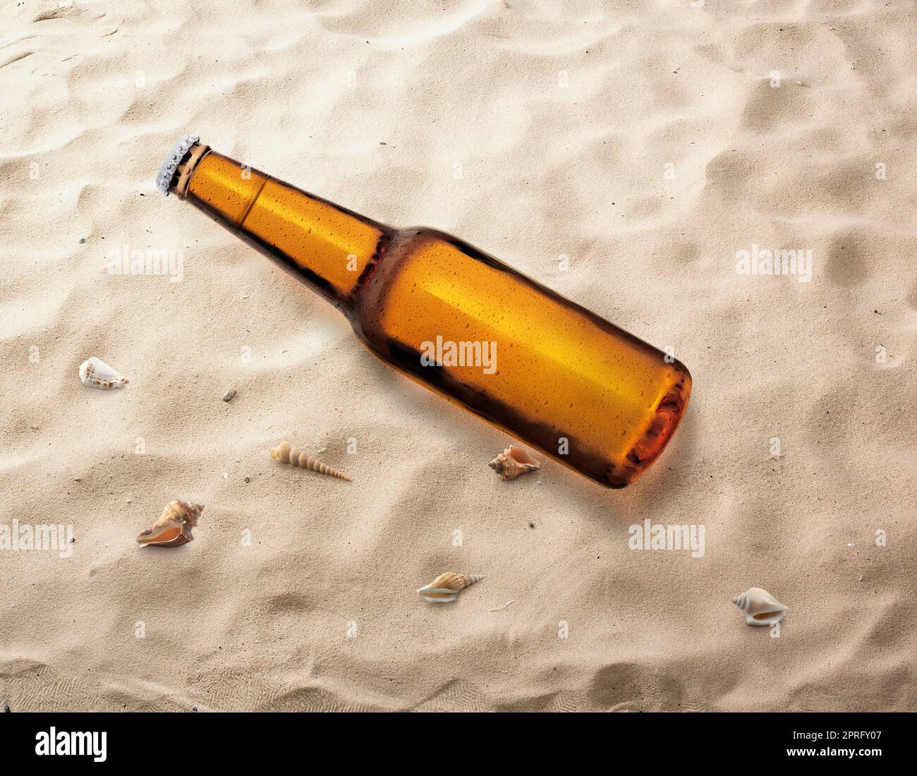 Bottle of beer on the beach being carried by sea waves to the shore ...