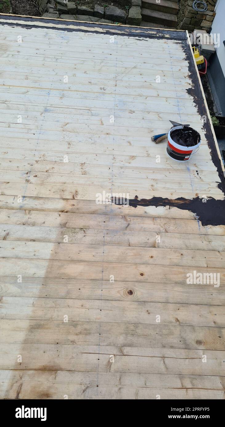 Flat roof repair: roofer welds roof waterproofing. Roof renovation with ...