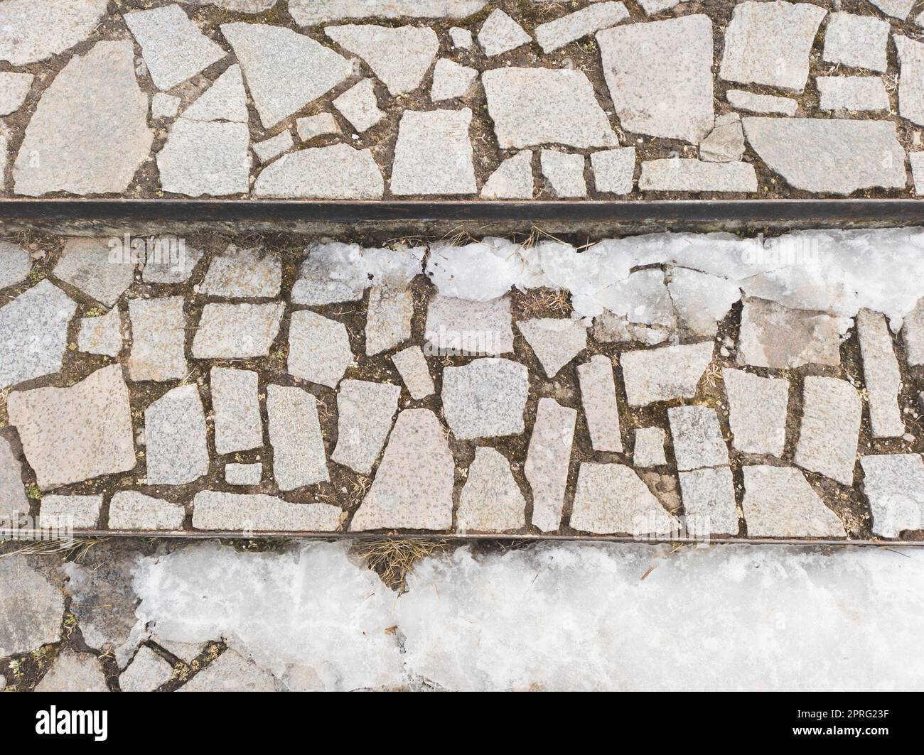 Melting snow on cobblestone pavement steps Stock Photo - Alamy