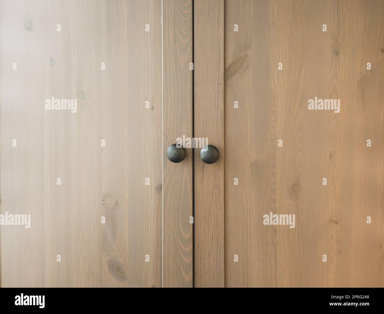 Wooden cupboard doors with round handles. wood background Stock Photo ...