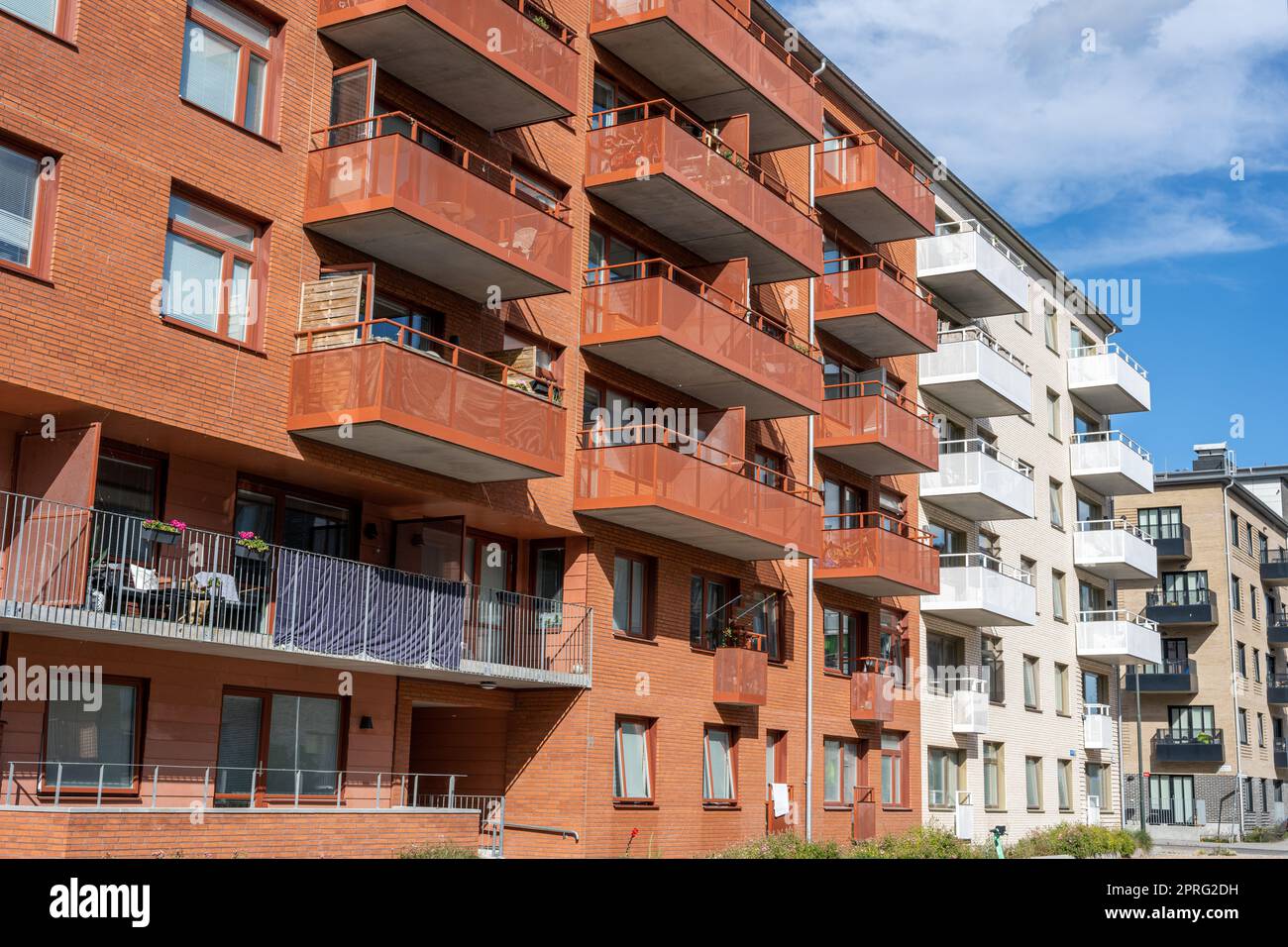 Red and white apartment buildings with many balconies seen in Berlin ...