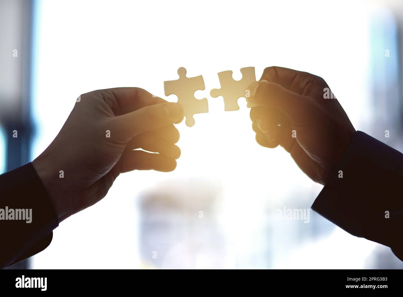 Trying to find the perfect fit. two people holding puzzle pieces ...