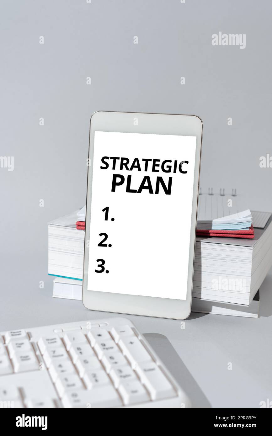 Hand writing sign Strategic PlanA process of defining strategy and ...
