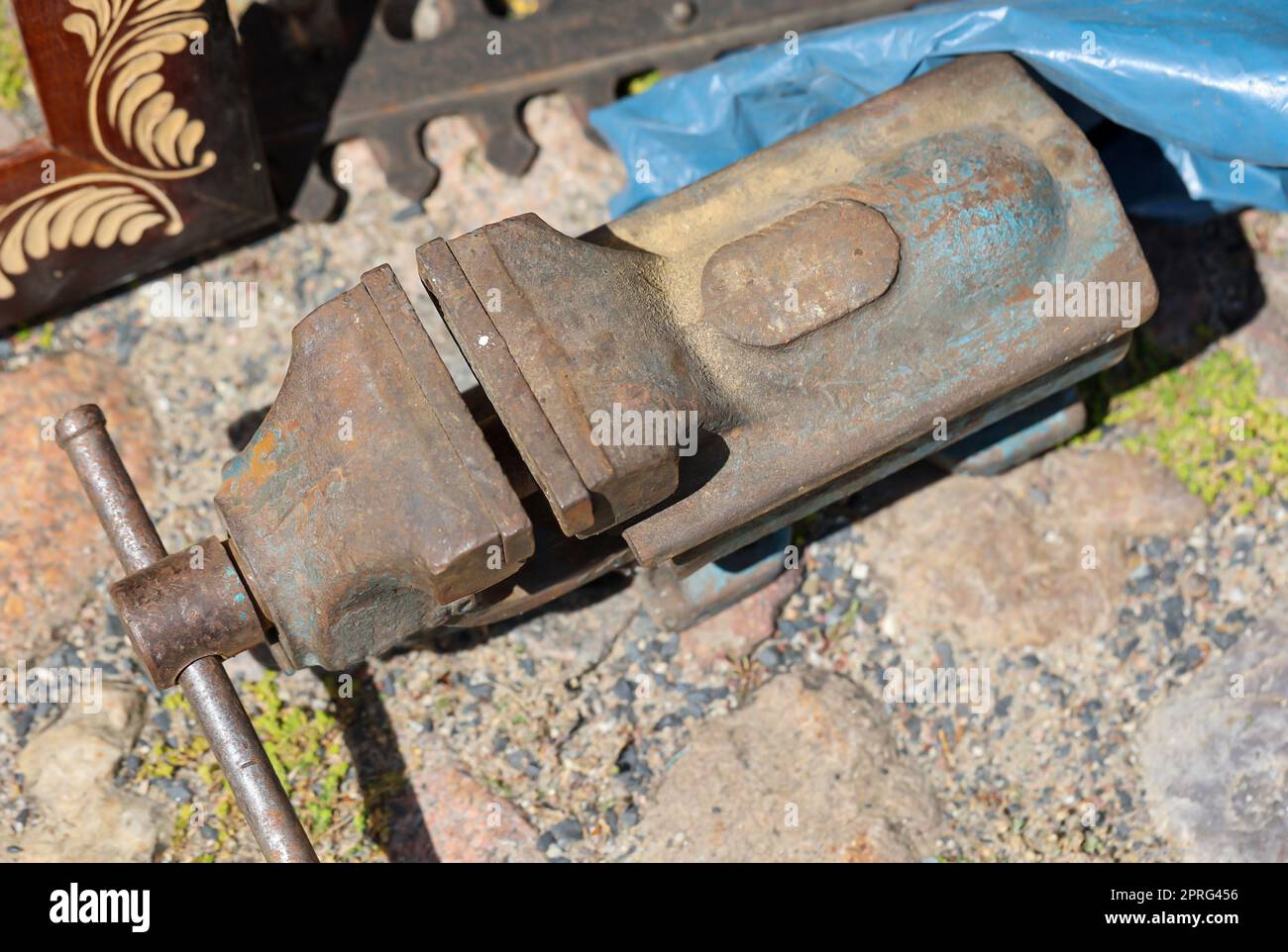 An age large vice stands on a paved floor Stock Photo - Alamy