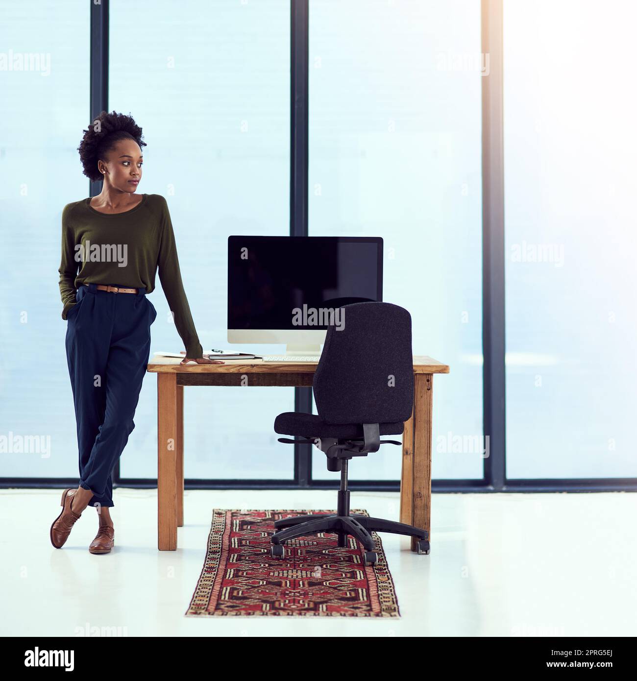 She has her eyes on success. a young designer leaning on her work ...