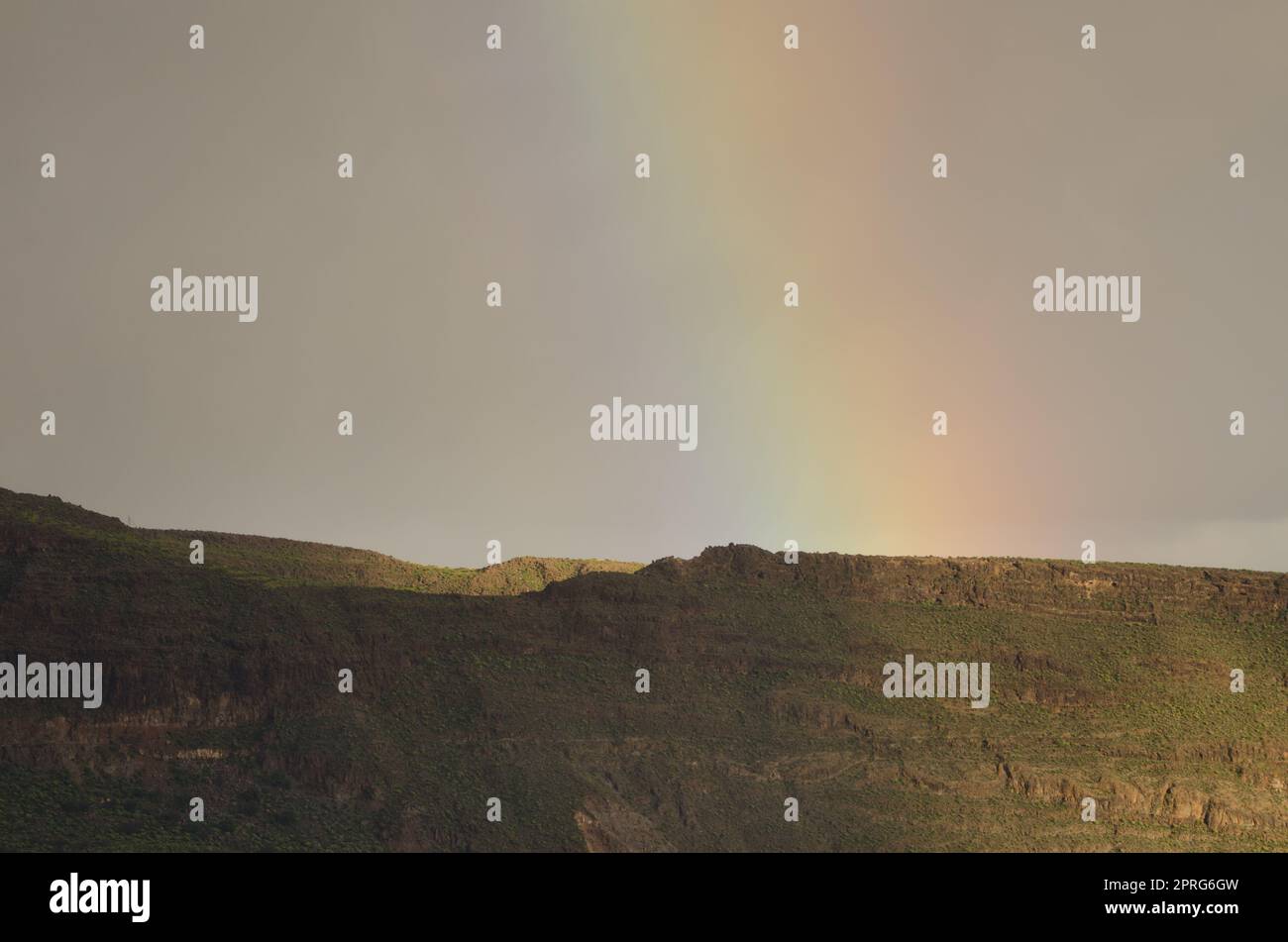Rainbow over a ridge of the Tirajana crater Stock Photo - Alamy