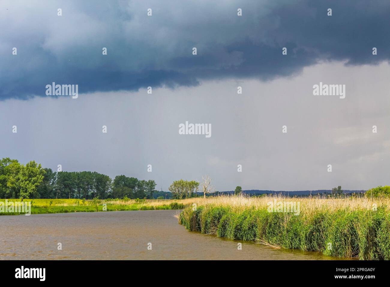 Heavy rain storm clouds wind waves water Oste river Germany Stock Photo ...