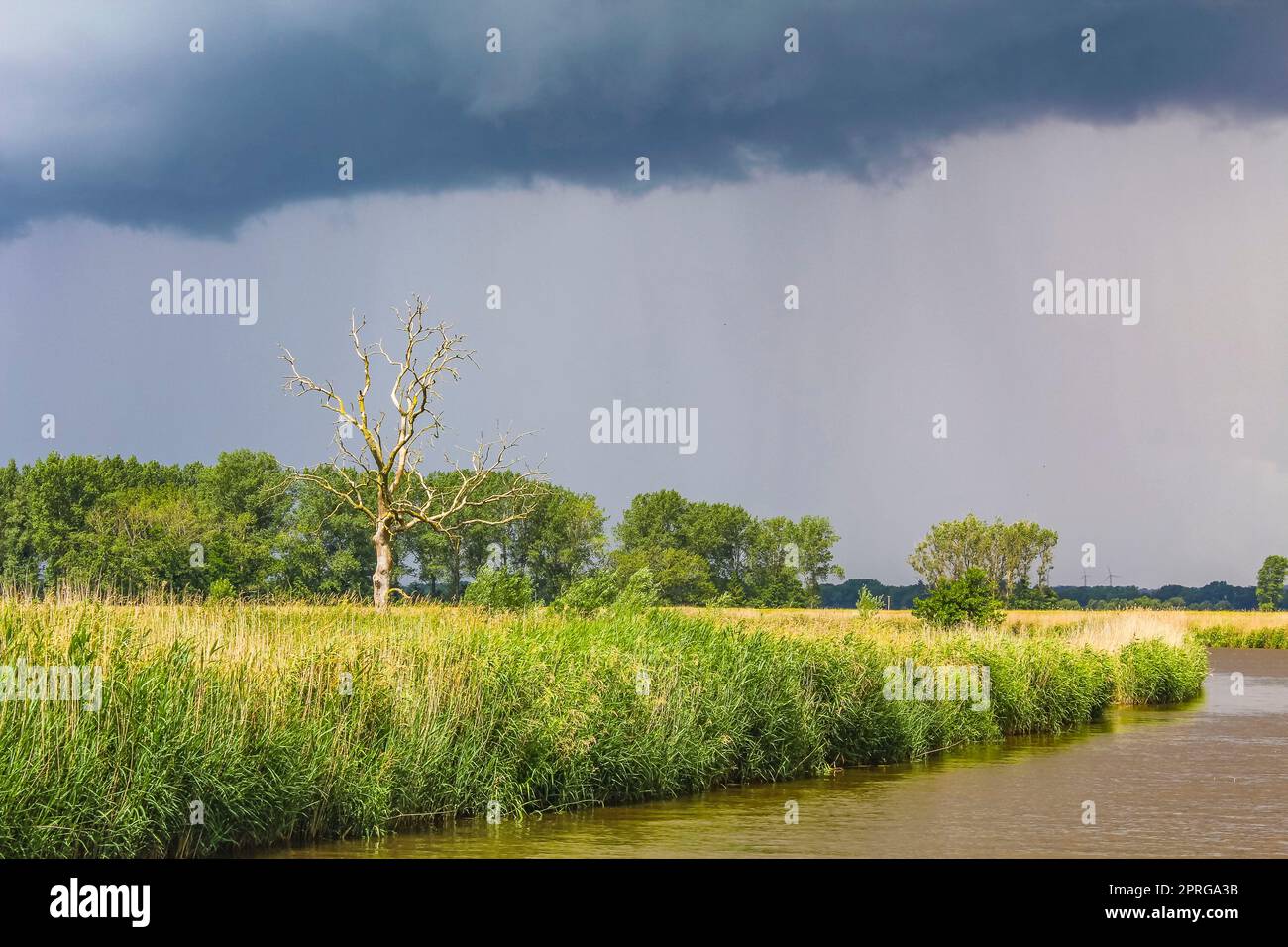Heavy rain storm clouds wind waves water Oste river Germany Stock Photo ...