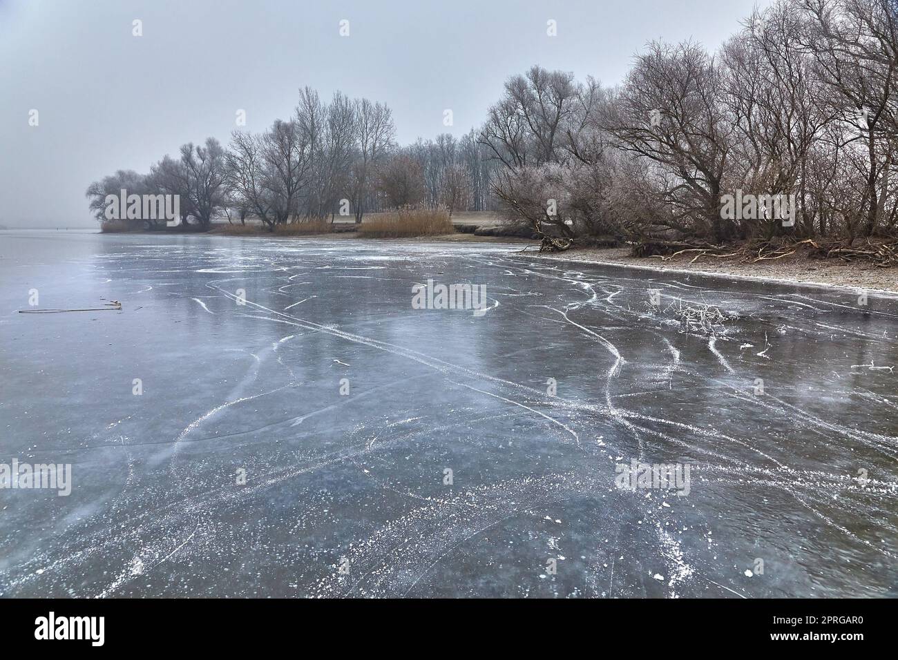 Frozen lake surface in cold winter landscape Stock Photo - Alamy