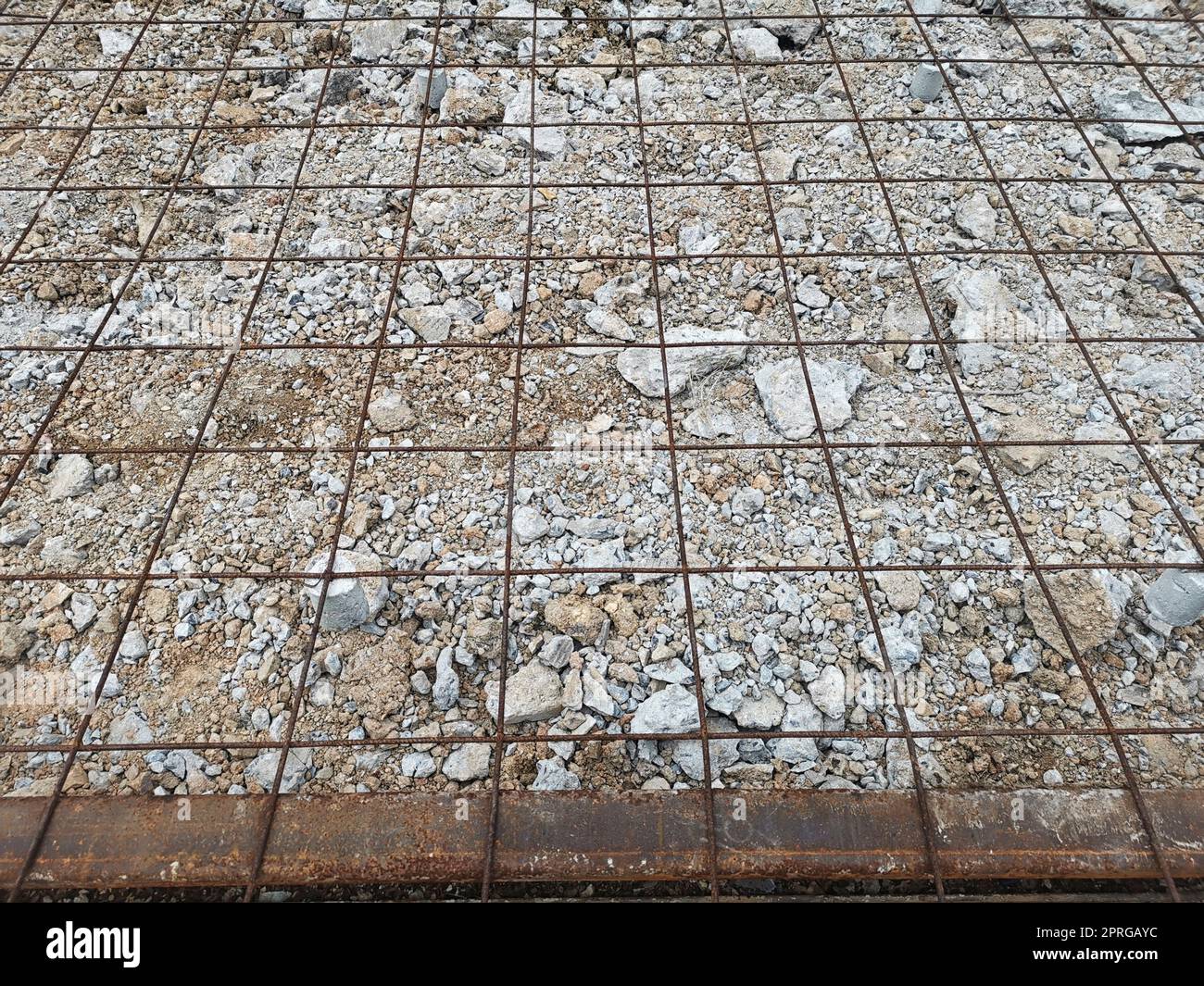 Steel wire mesh laying on stone mix to process create concrete road ...