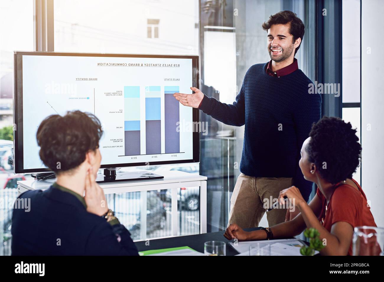 Looking back at their numbers. a young businessman giving a ...