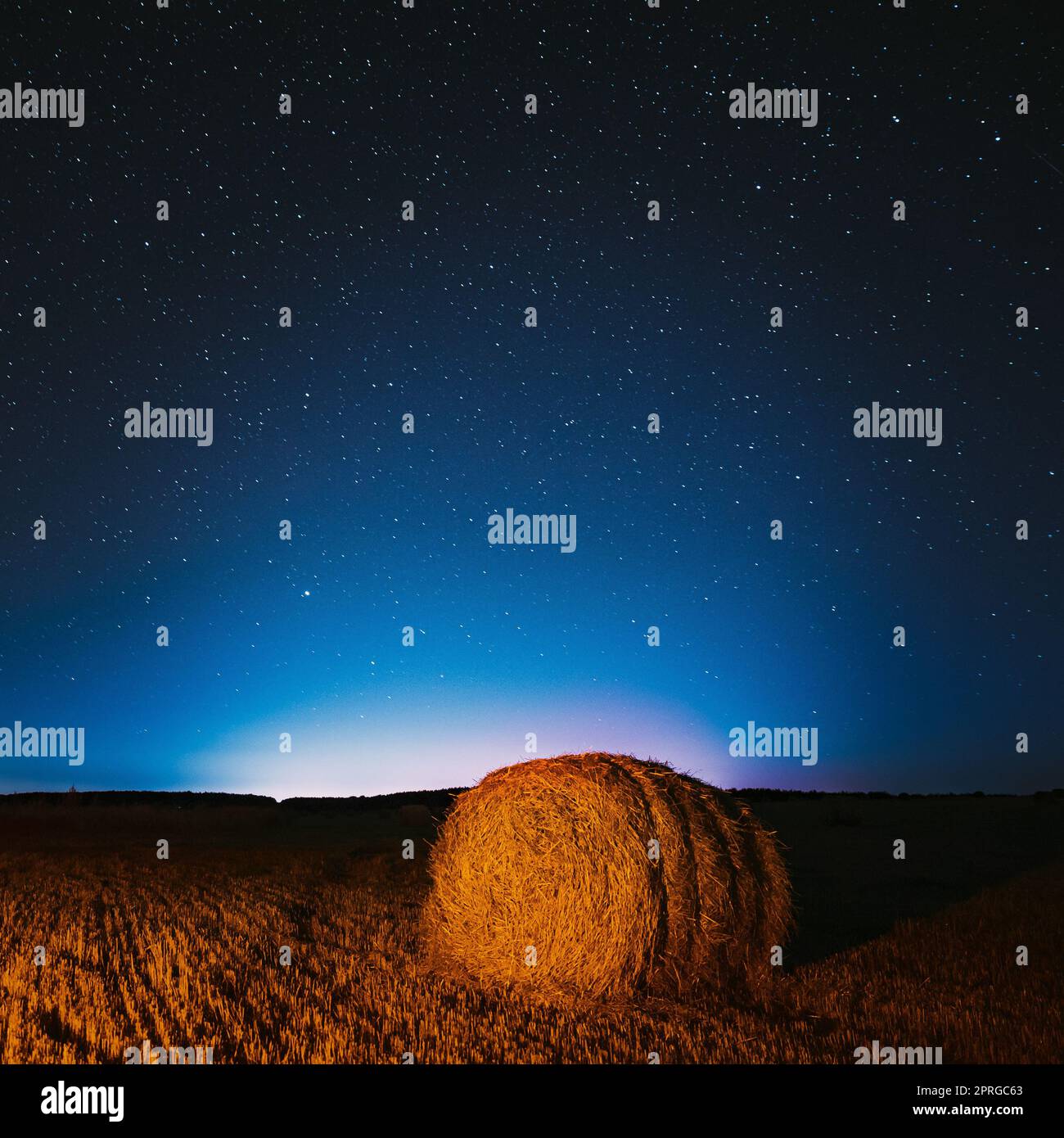 Night Starry Sky Above Haystacks In Summer Agricultural Field. Night ...