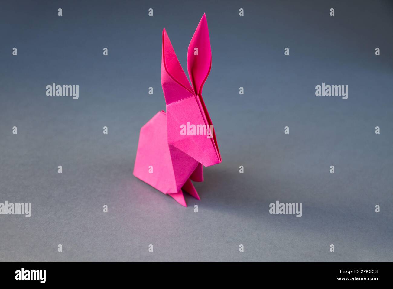 Pink paper rabbit origami isolated on a grey background Stock Photo - Alamy