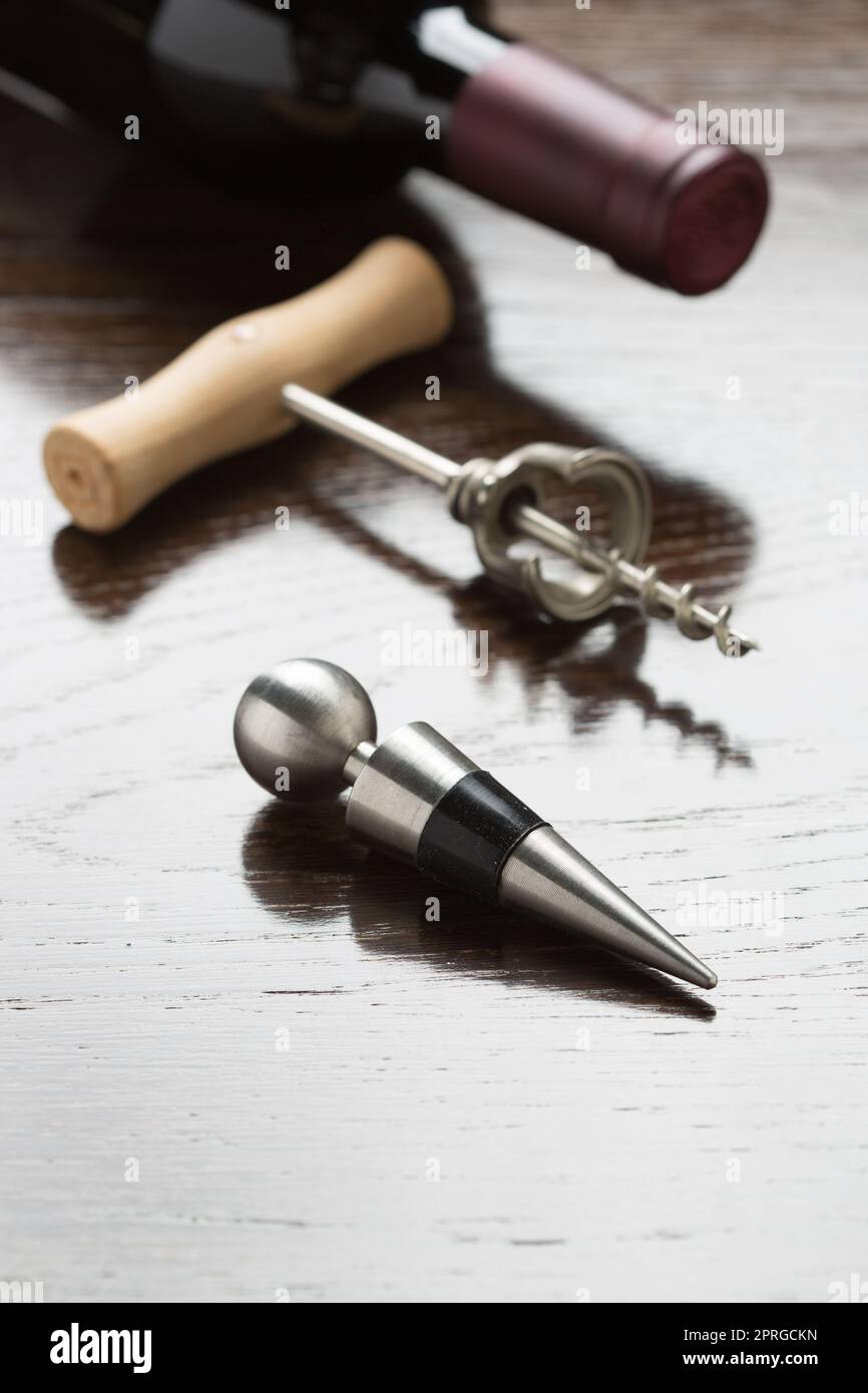 Abstract Wine Bottle, Corkscrew and Stopper Laying on a Reflective Wood ...
