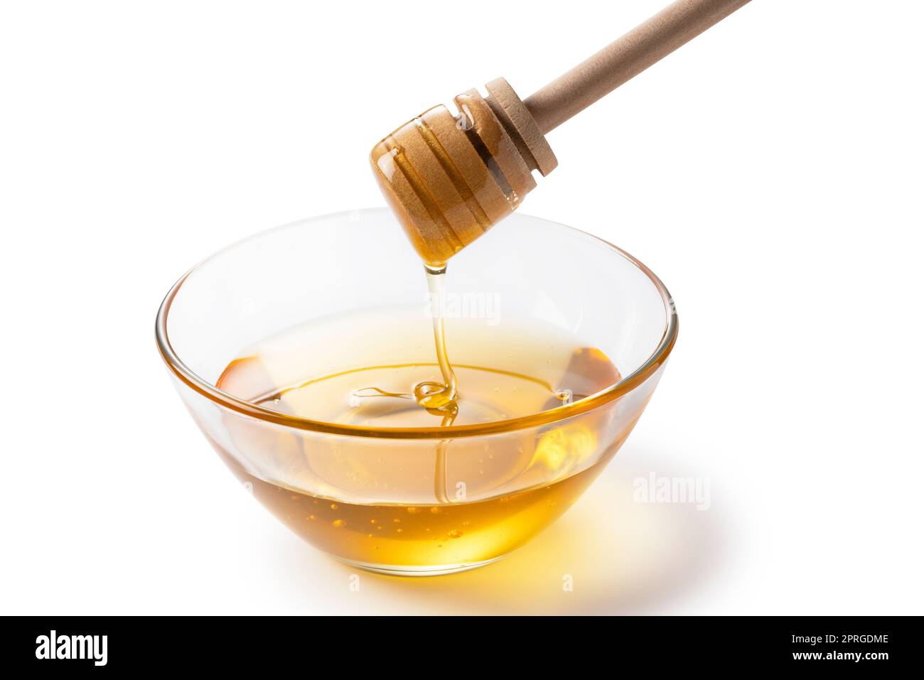 Honey and honey dippers in glass bowl on white background. Honey drips ...