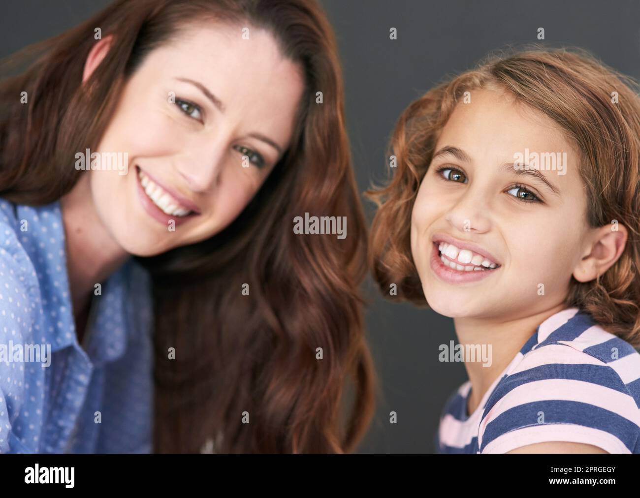 One-on-one time with mom. Portrait of a mother and her daughter against ...